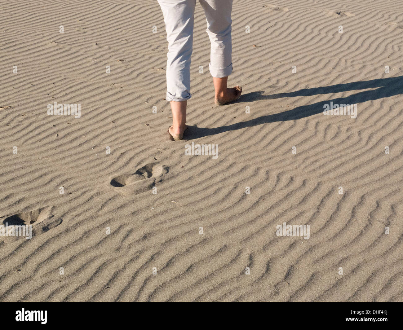 Walking in the sand of a beach Stock Photo - Alamy