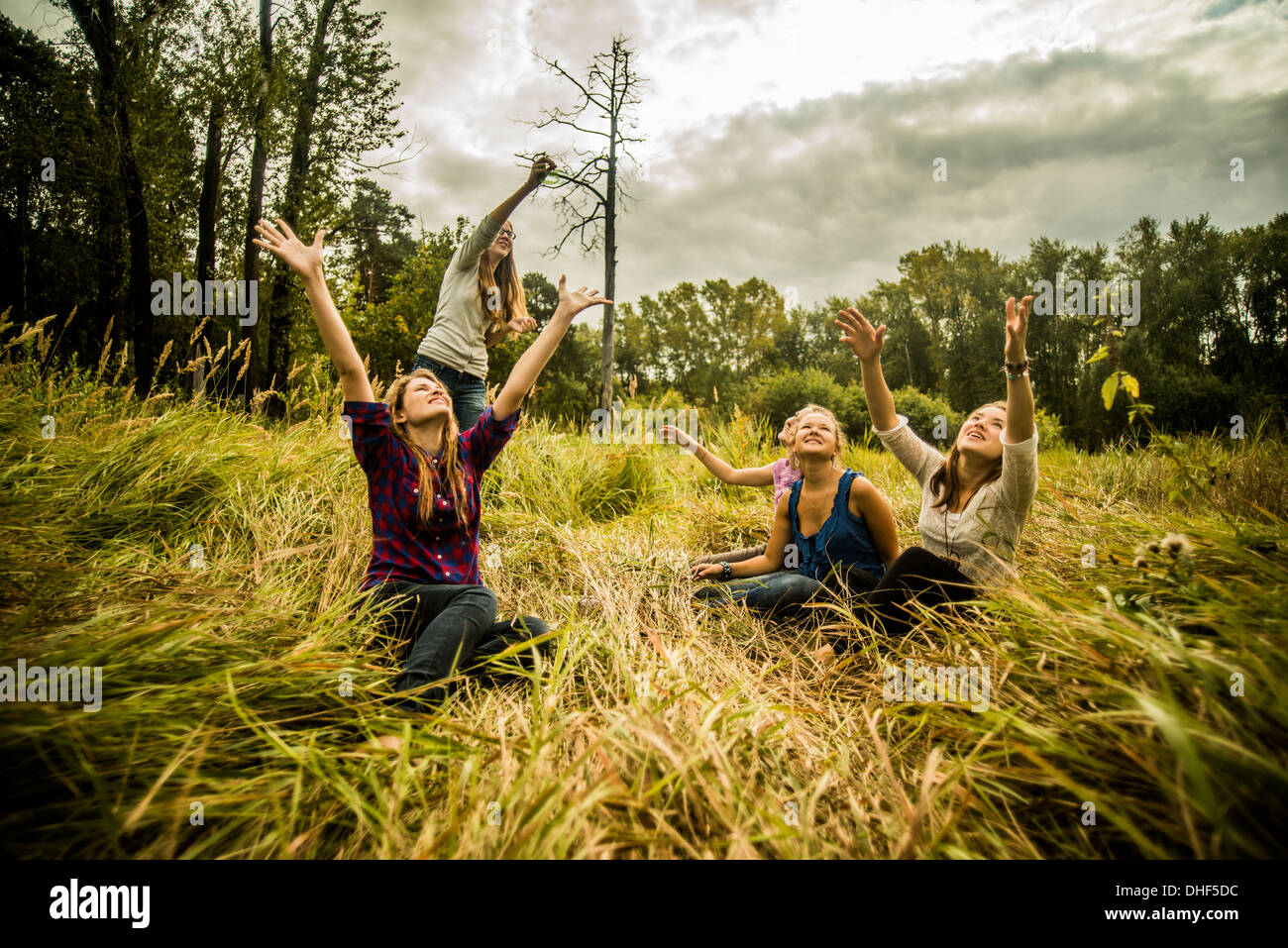 Five young women watching kite Stock Photo - Alamy