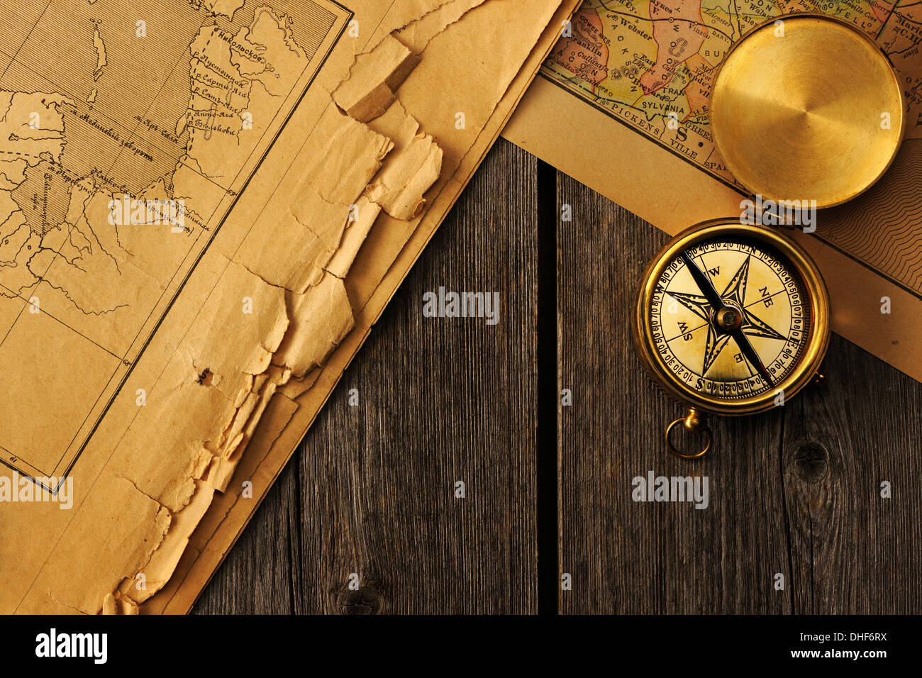 Antique compass over old map Stock Photo - Alamy