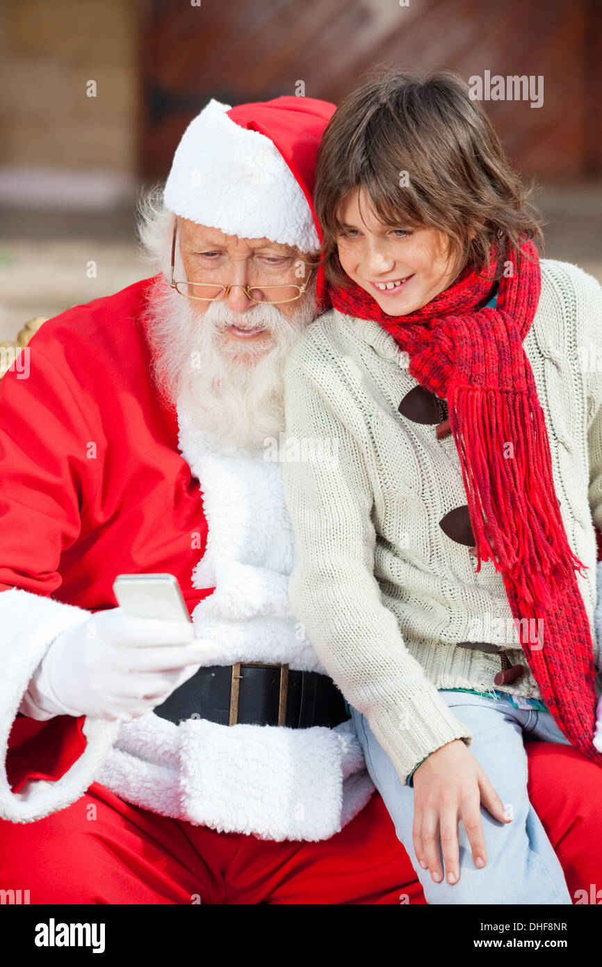 Santa Claus And Boy Using Smartphone Stock Photo - Alamy