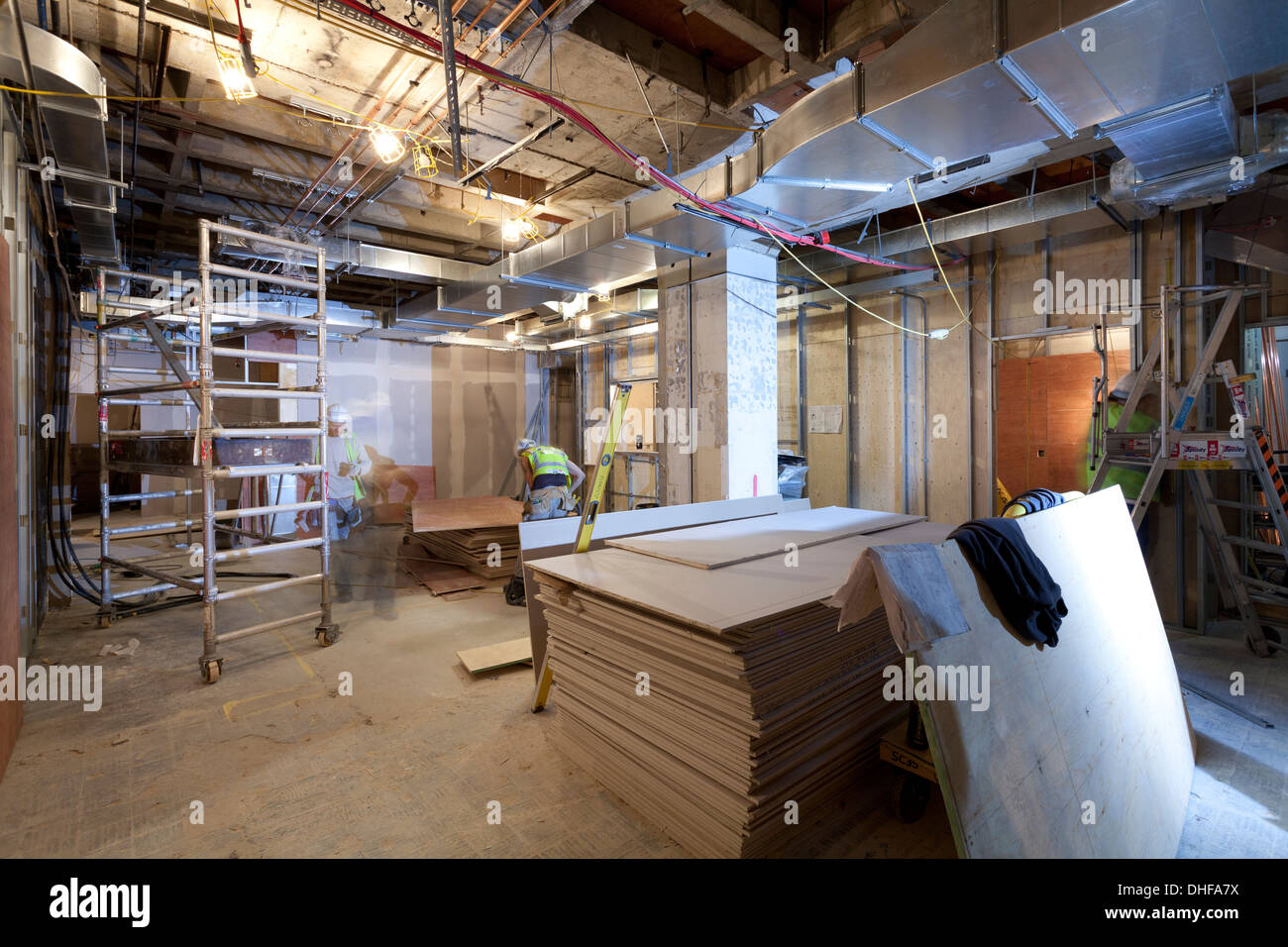 Builders working inside a construction site Stock Photo - Alamy