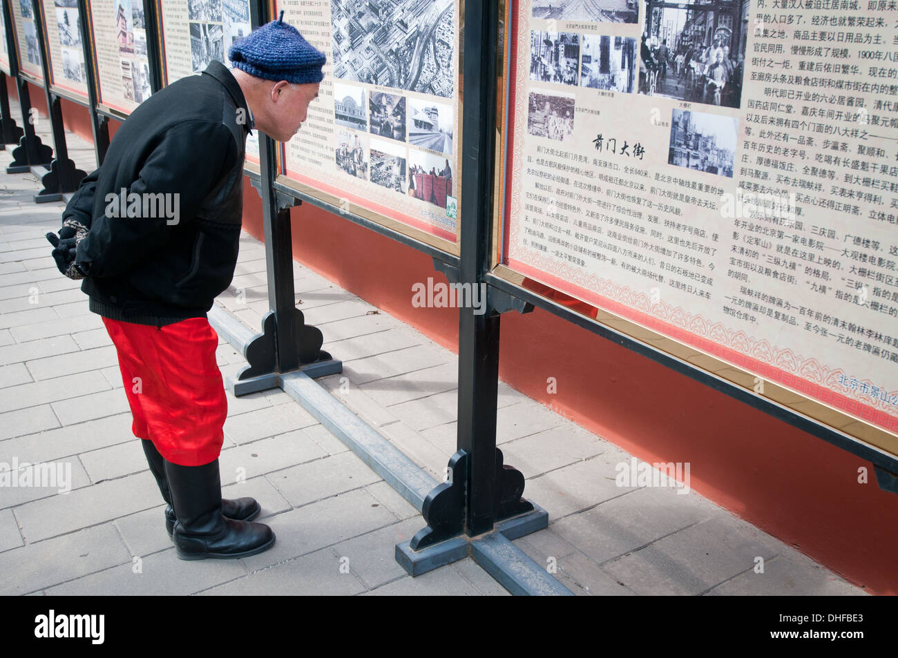 Chinese man looking at exhibition of archival photographs in Jingshan ...