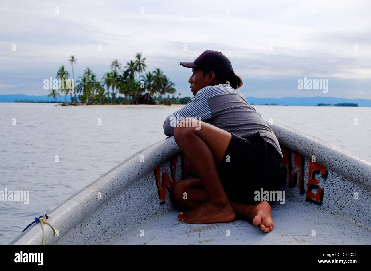 Young man from the Guna people boating in a small island fringed with ...