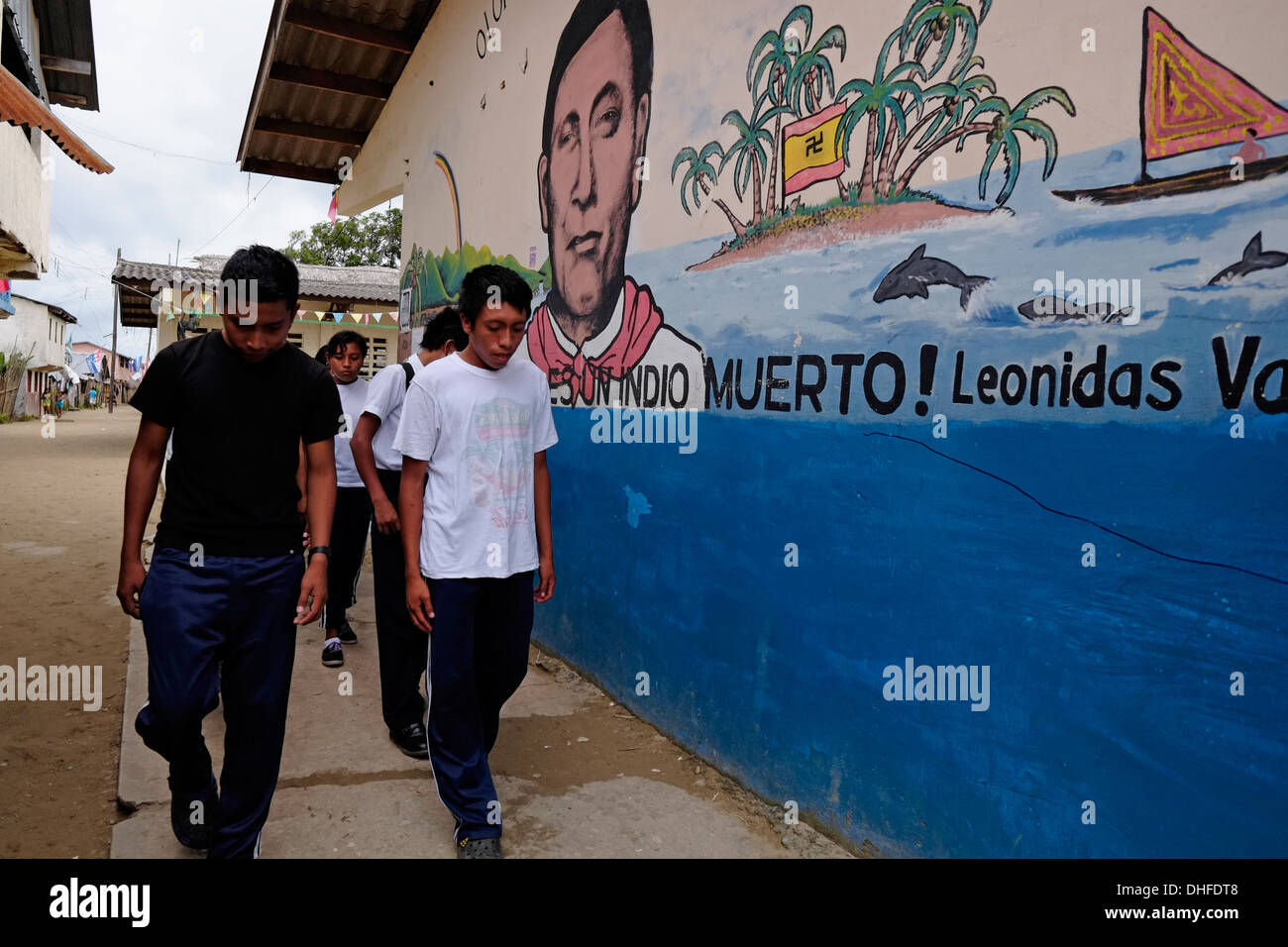 Schoolchildren from the Guna people walk past a painted wall depicting ...