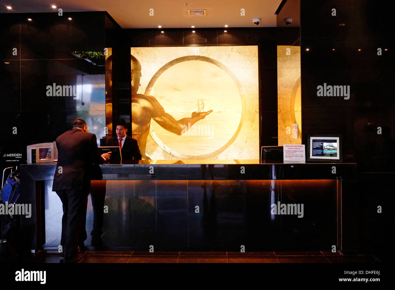 A front desk agent registers a guest at the front desk of Le Meridien ...