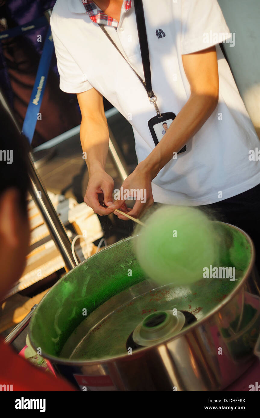 Making candy floss as a kid waits Stock Photo - Alamy