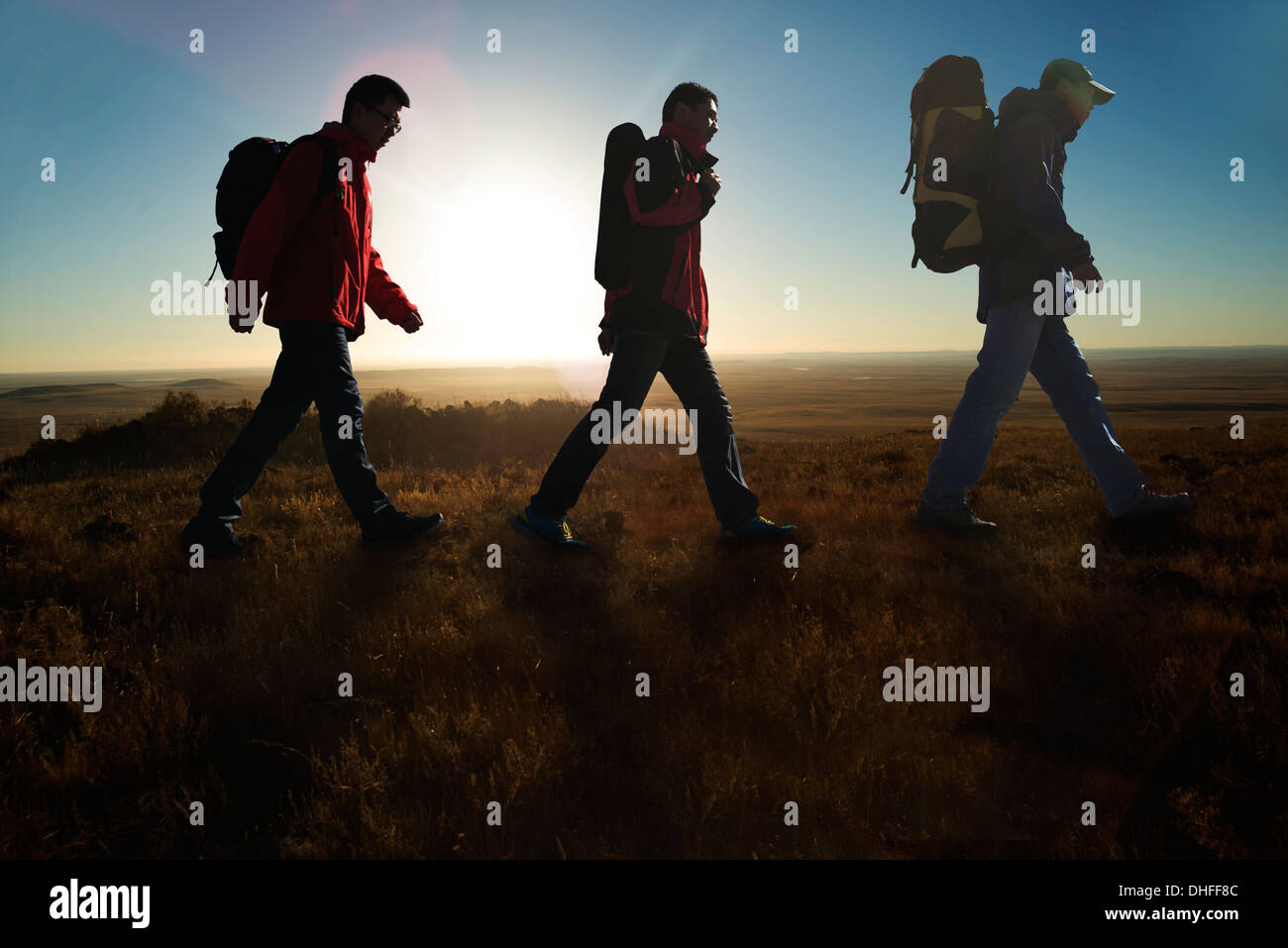 The three hikers walk trip, in the top of the sunrise Stock Photo - Alamy