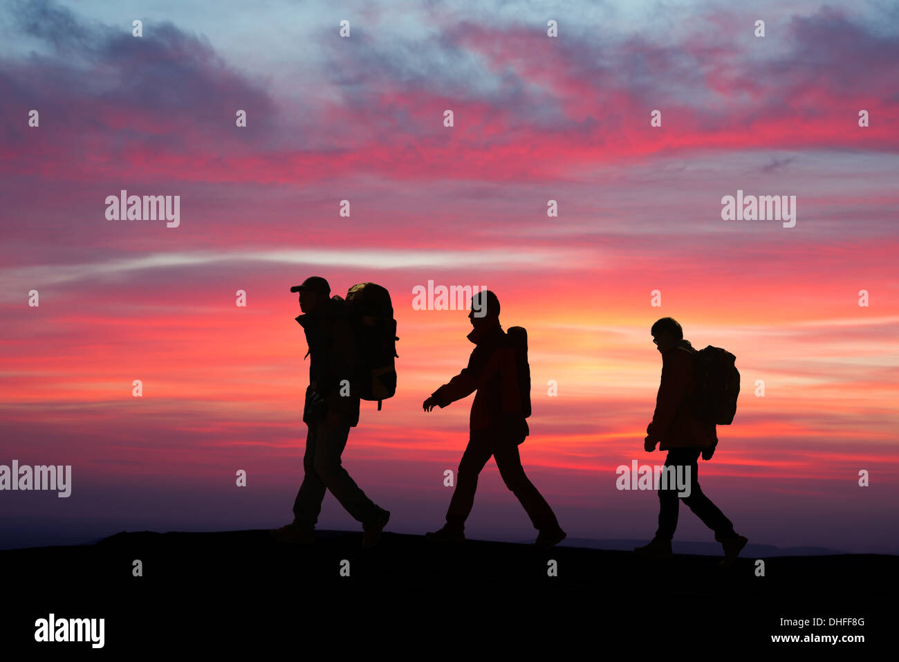 The three hikers walk trip, in the top of the sunrise Stock Photo - Alamy
