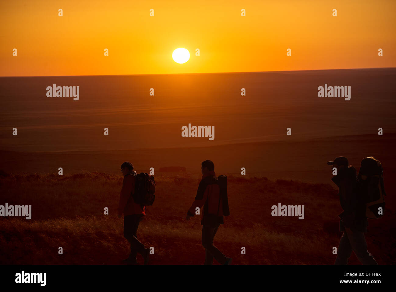 The three hikers walk trip, in the top of the sunrise Stock Photo - Alamy