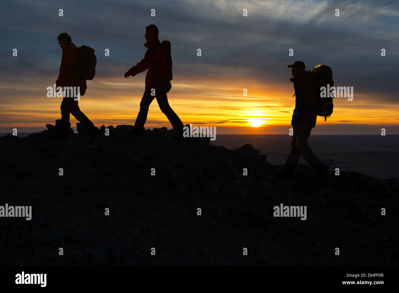 The three hikers walk trip, in the top of the sunrise Stock Photo - Alamy
