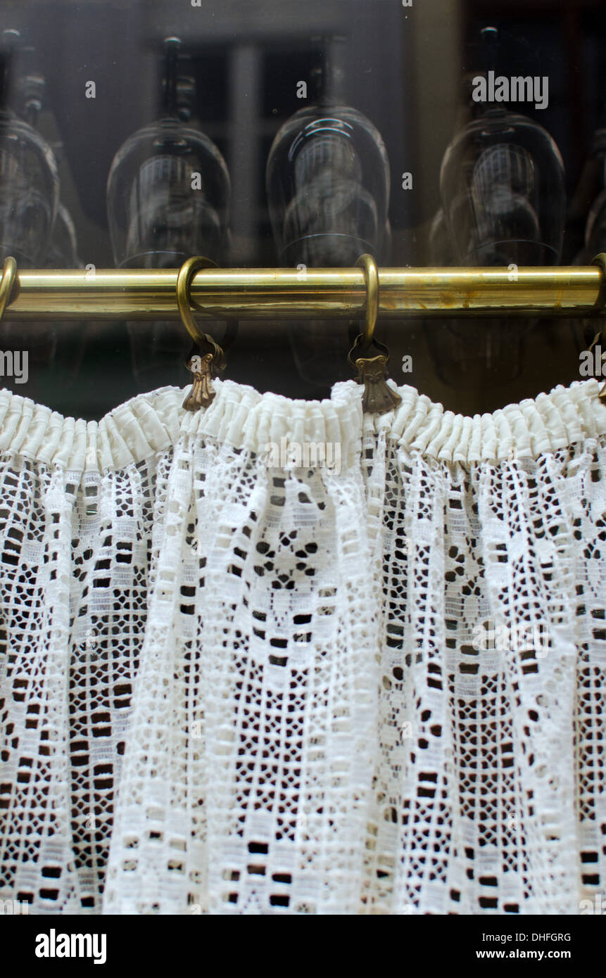 crochet curtain at holder rings in a restaurant. shot through the ...