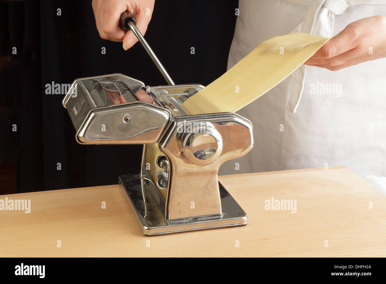 rolling pasta sheets with a machine Stock Photo - Alamy