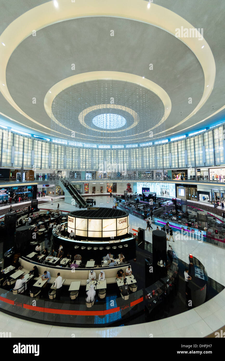 Interior of large atrium with cafes and shops at Dubai Mall in Dubai ...
