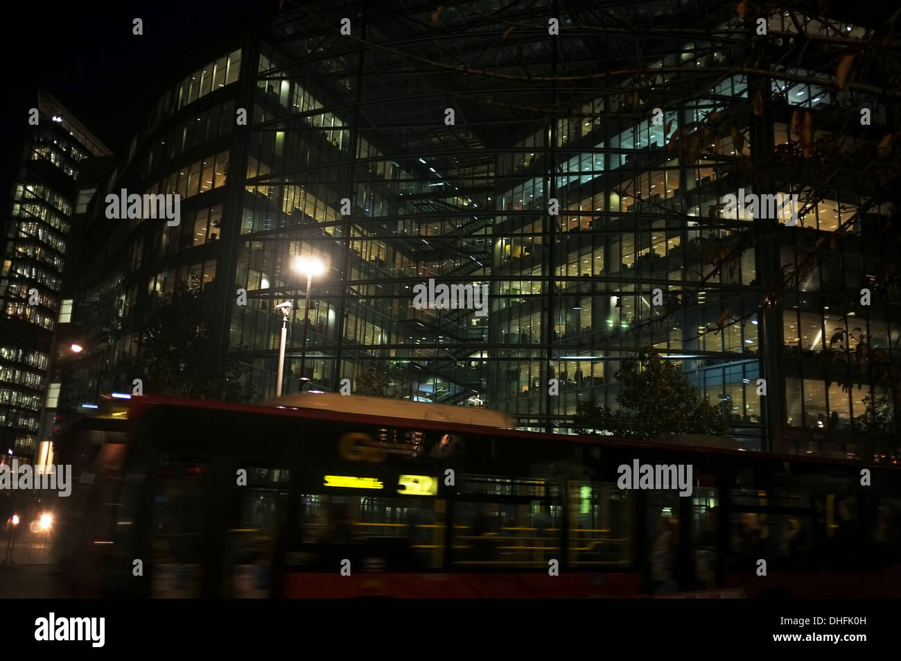 Office lights at night on a tower building Stock Photo - Alamy