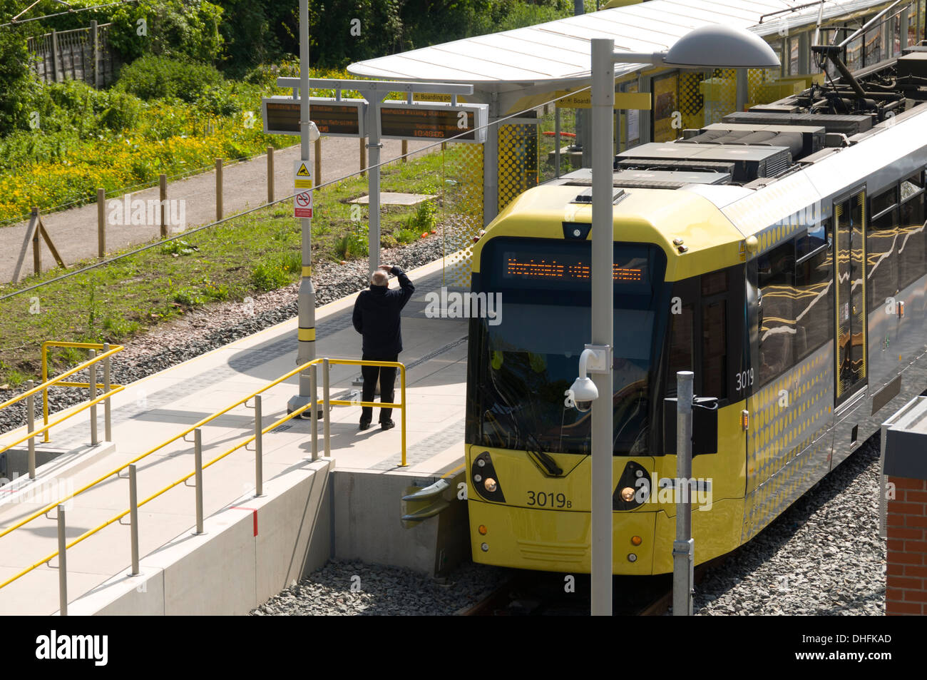 Man reading a Passenger Information Display (PID) at East Didsbury ...