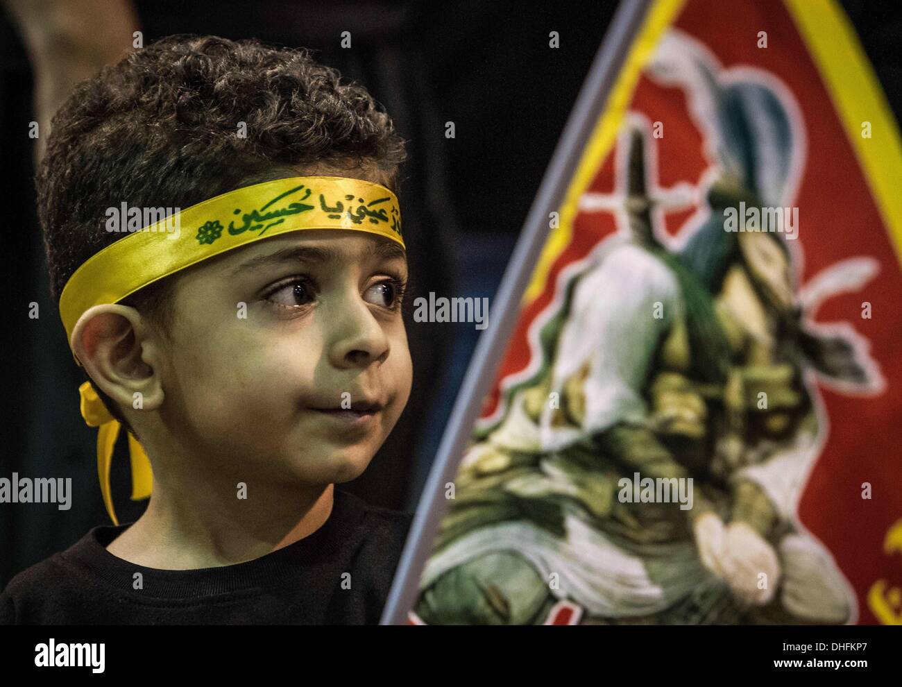 Manama, Bahrain. 8th Nov, 2013. Kid holding flag with imam AlHussain ...