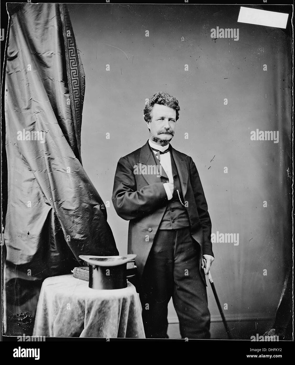 The photograph shows a man dressed in formal attire, representing a ...