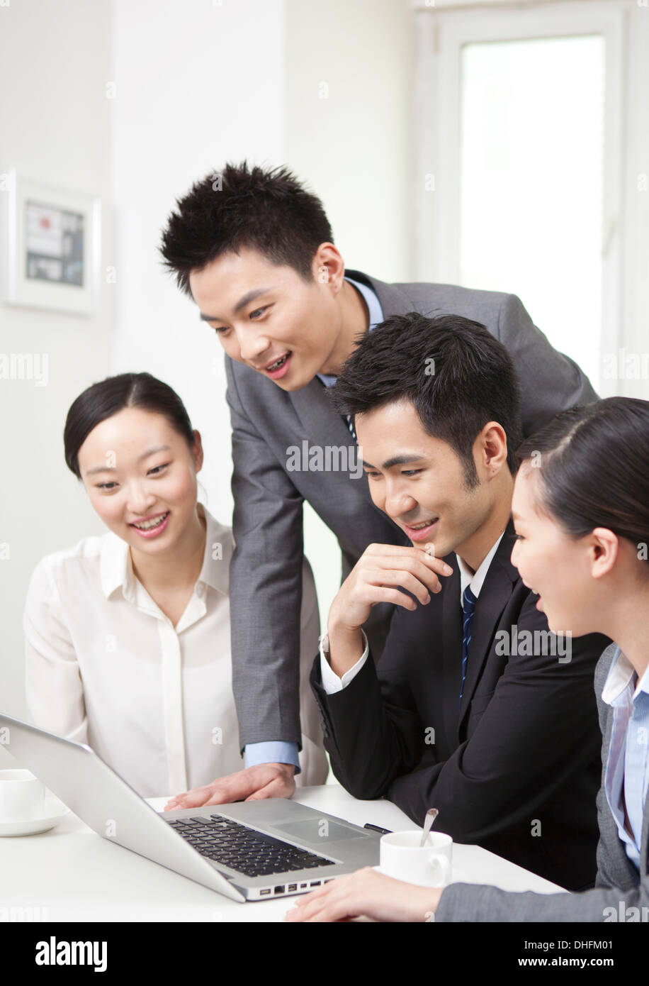 Group of businesspeople discussing,working on computer Stock Photo - Alamy