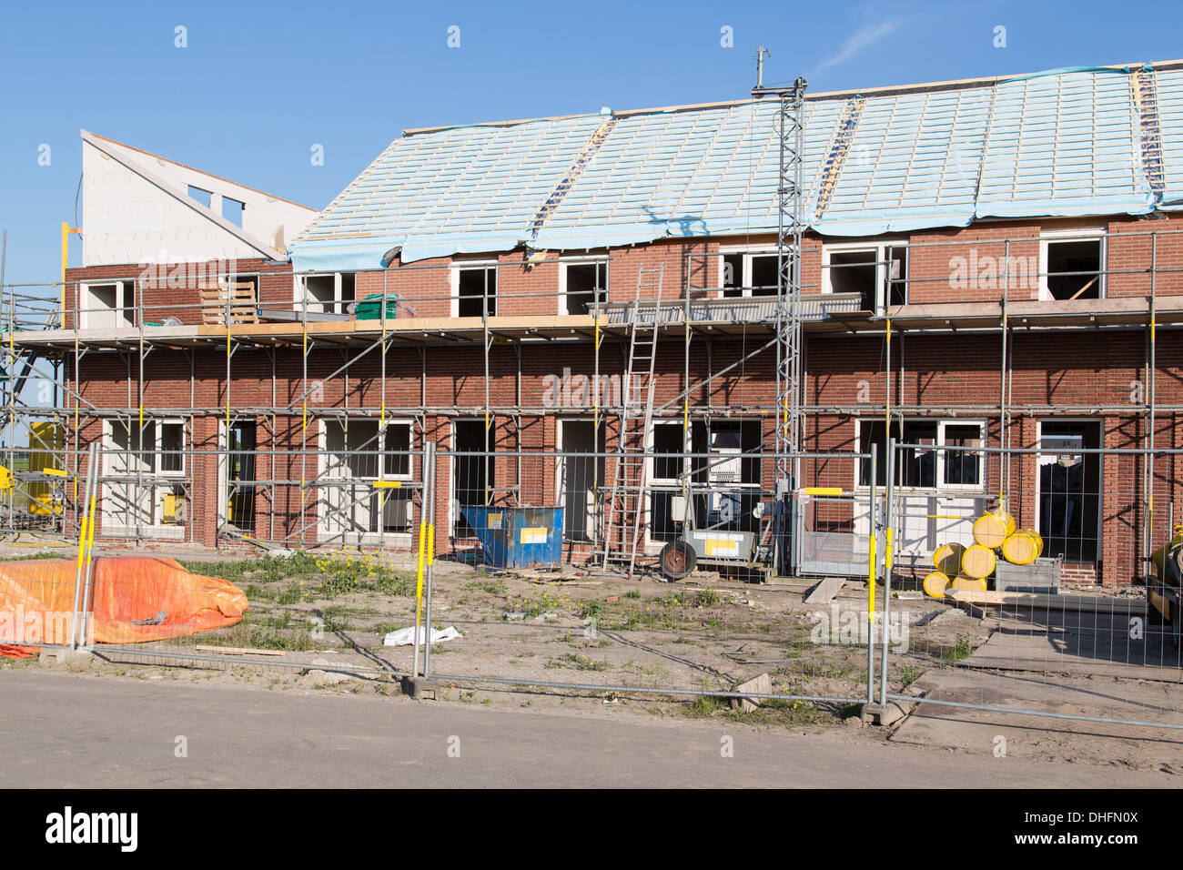 Construction site with family houses in scaffolding Stock Photo - Alamy