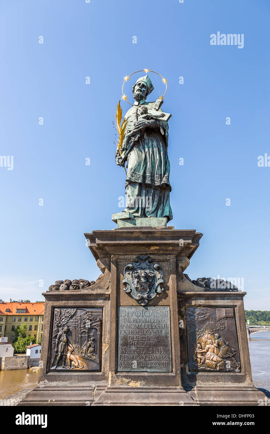 John of Nepomuk statue on Charles Bridge in Prague. Touching the relief ...