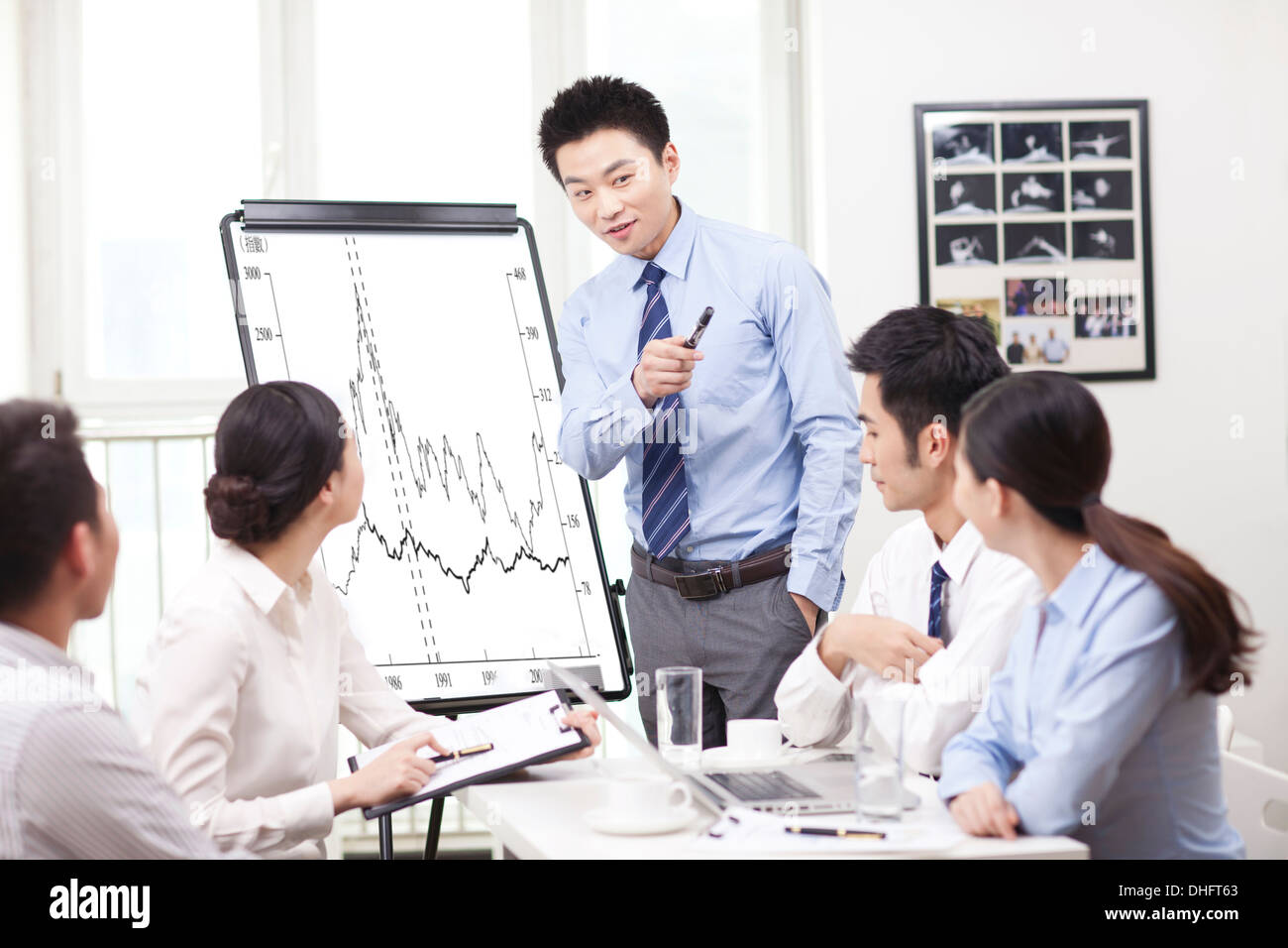 Businessman pointing at graph during presentation in boardroom Stock ...
