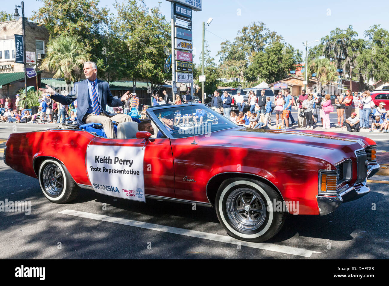 Florida State Representative Keith Perry rides in open red vintage ...