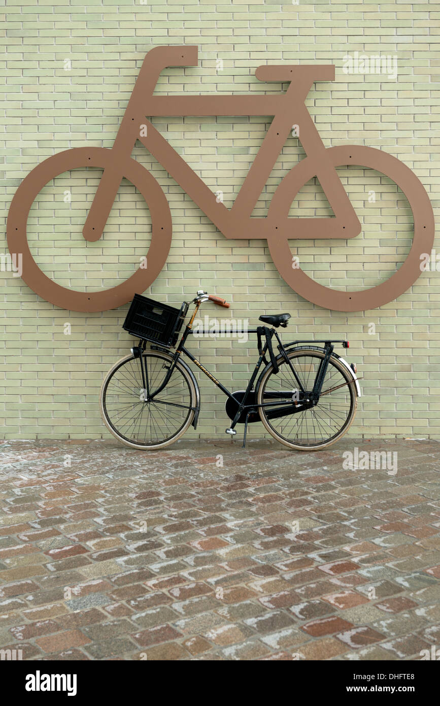 A typical dutch bicycle leant underneath a large bike symbol in ...