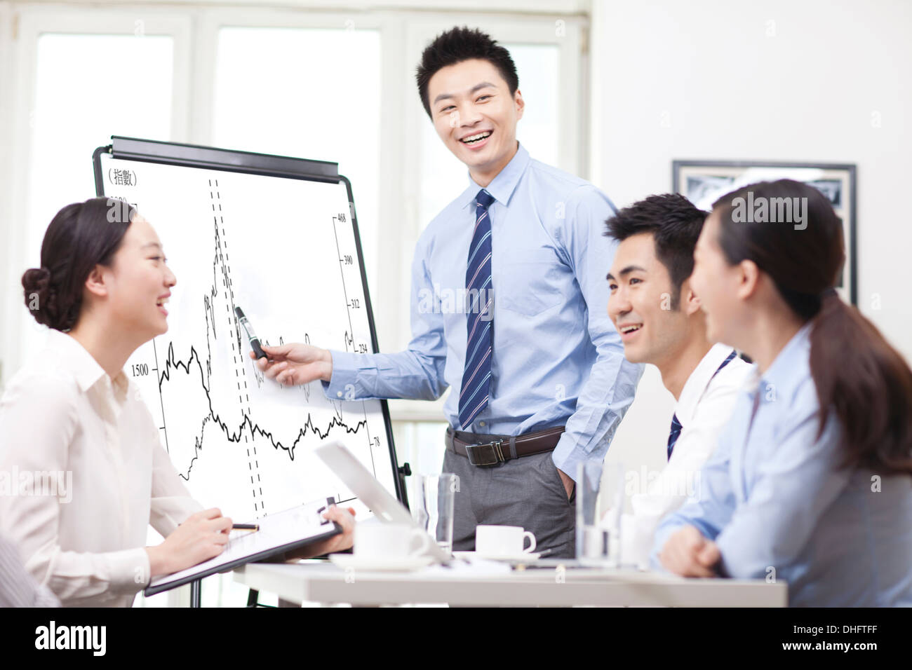 Businessman pointing at graph during presentation in boardroom Stock ...