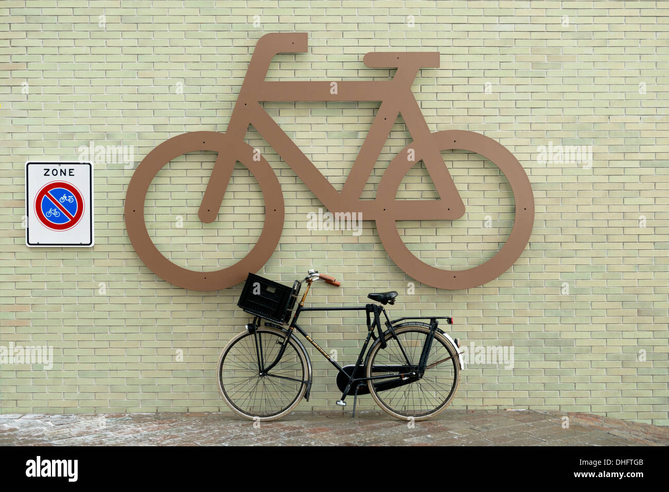 A typical dutch bicycle leant underneath a large bike symbol in ...