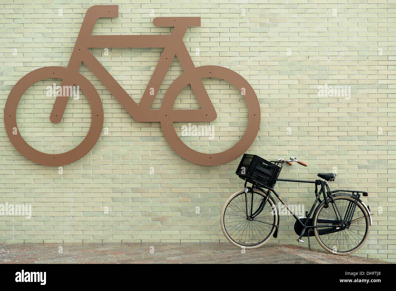 A typical dutch bicycle leant underneath a large bike symbol in ...