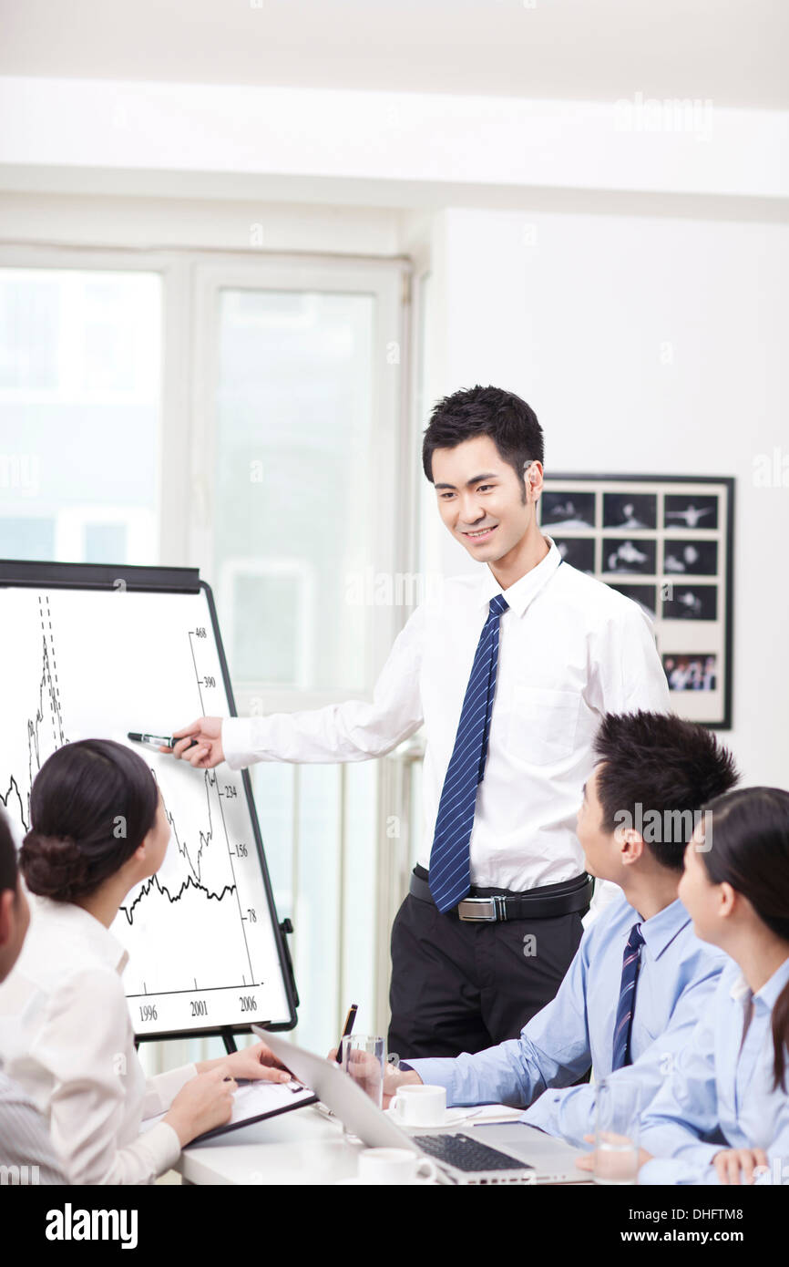 Businessman pointing at graph during presentation in boardroom Stock ...