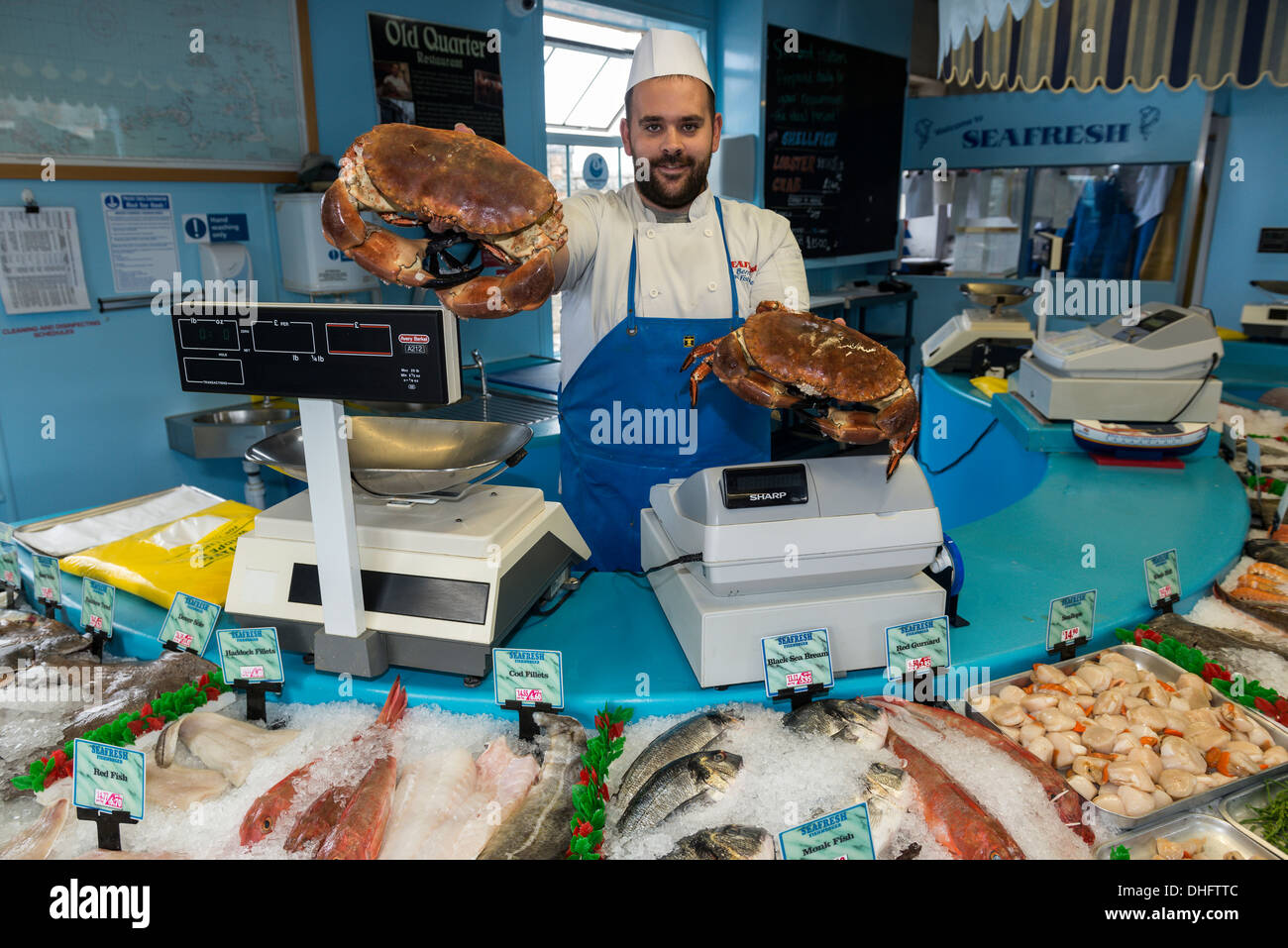 Fishmonger holding two edible Brown crab to the camera. Seafresh ...