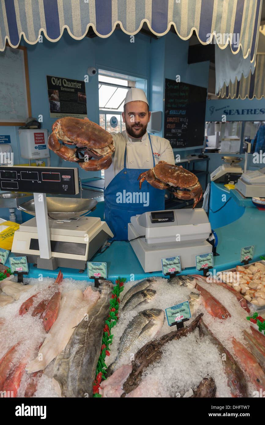 Fishmonger holding two edible Brown crab to the camera. Seafresh ...