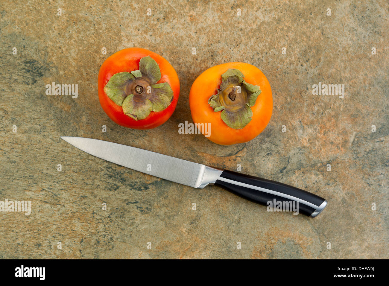 Horizontal photo of dry fresh persimmons with single knife lying on ...