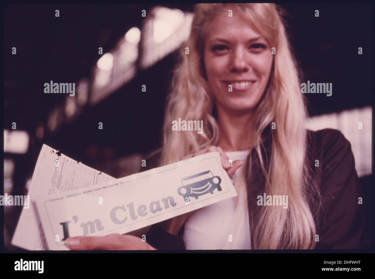 A young woman proudly displays a bumper sticker indicating she ...