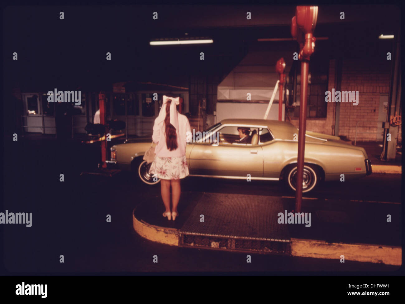 A woman waits at an auto emission inspection station in downtown ...