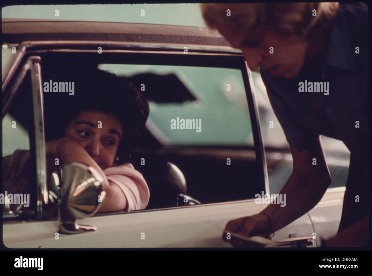This photograph shows a motorist receiving the news that her car has ...
