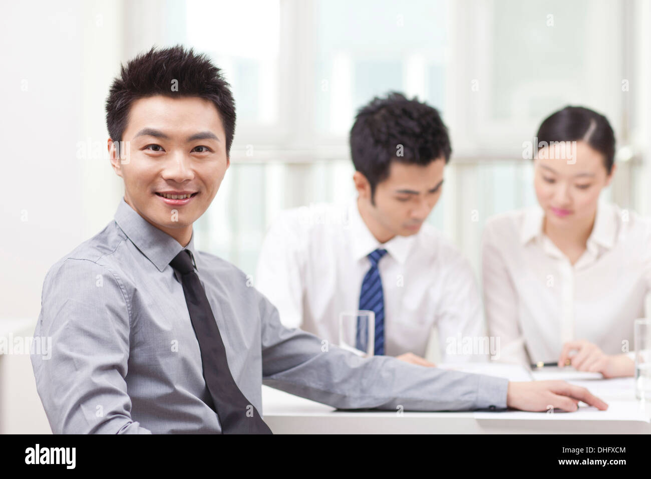 Executives sitting at conference table Stock Photo - Alamy