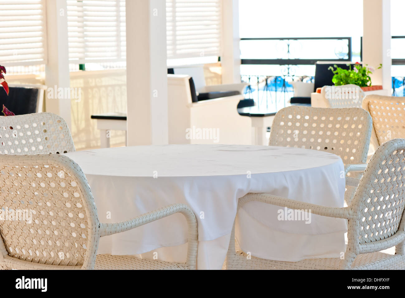 in the cafeteria wicker chairs and tables covered with cloth Stock ...