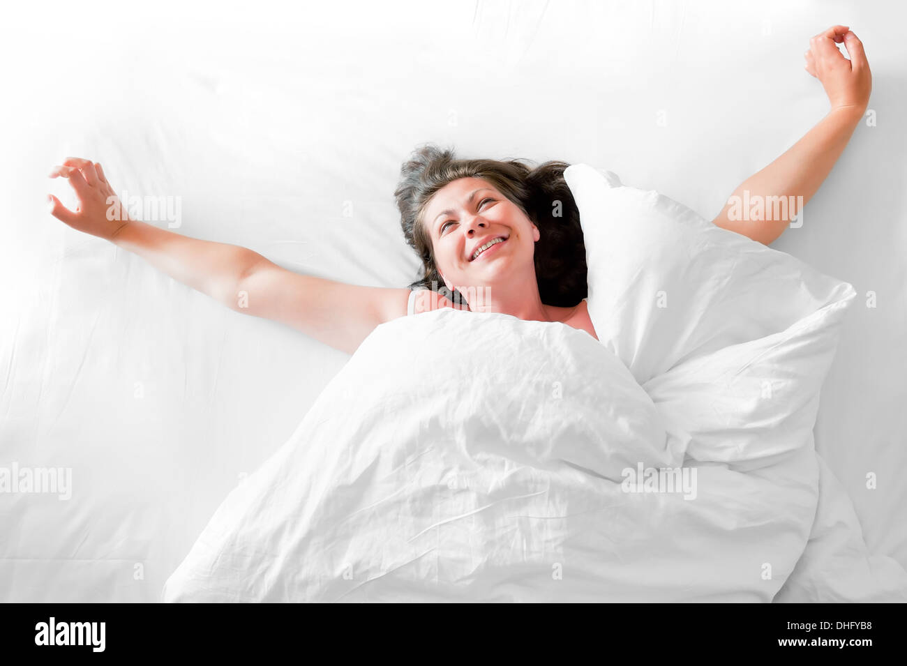 Photo of a young woman waking up happy with a morning stretch Stock ...