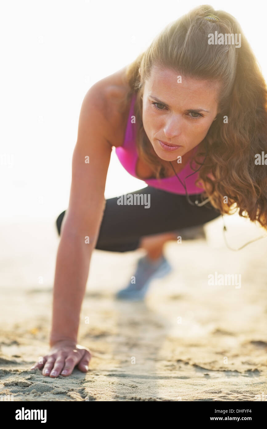 Fitness young woman making exercise on beach Stock Photo - Alamy