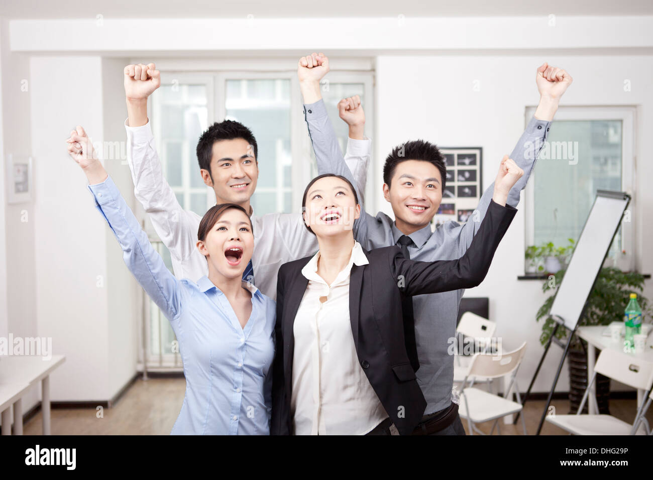 Group of young business people cheering Stock Photo - Alamy
