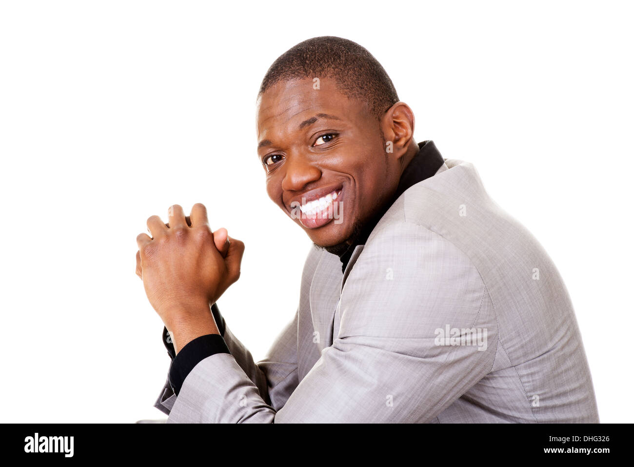 Businessman sitting with hands together. Side view. Isolated on white ...