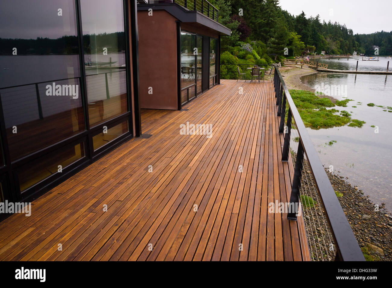 A beautiful waterfront home has the water view from the back wood deck ...