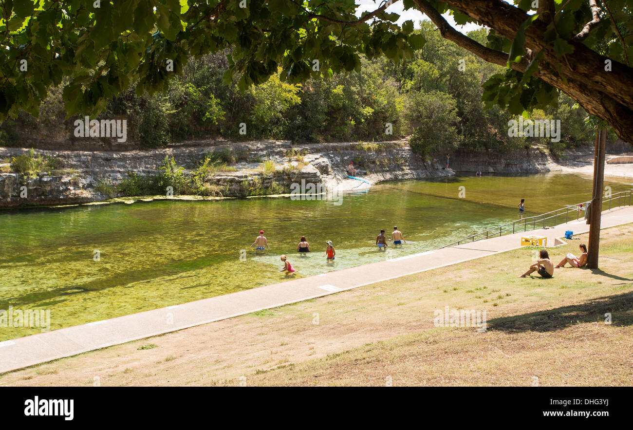 People swim in the outdoor swimming pool at Barton Springs Pool in ...