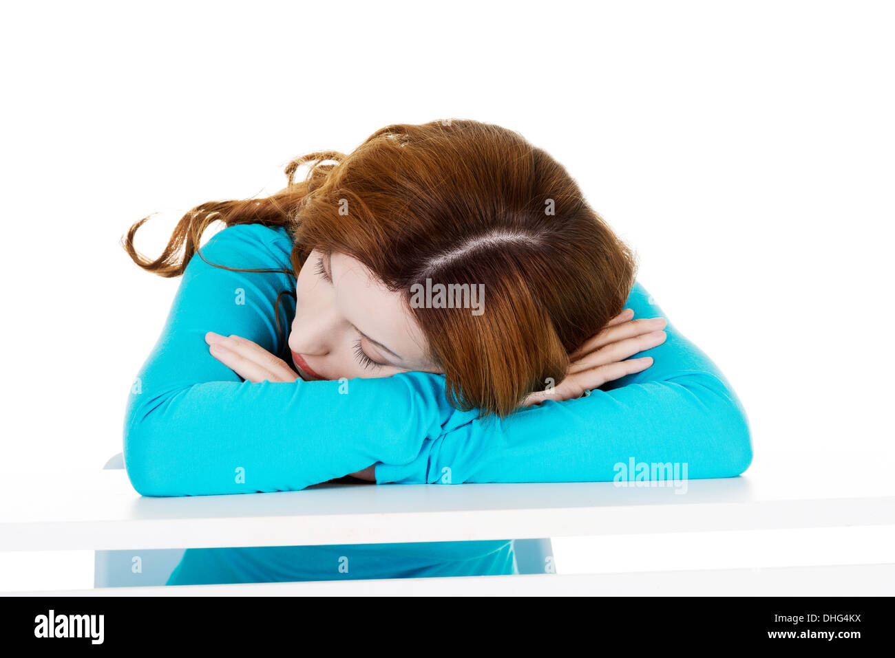Beautiful casual woman sleeping on a table. Isolated on white Stock ...