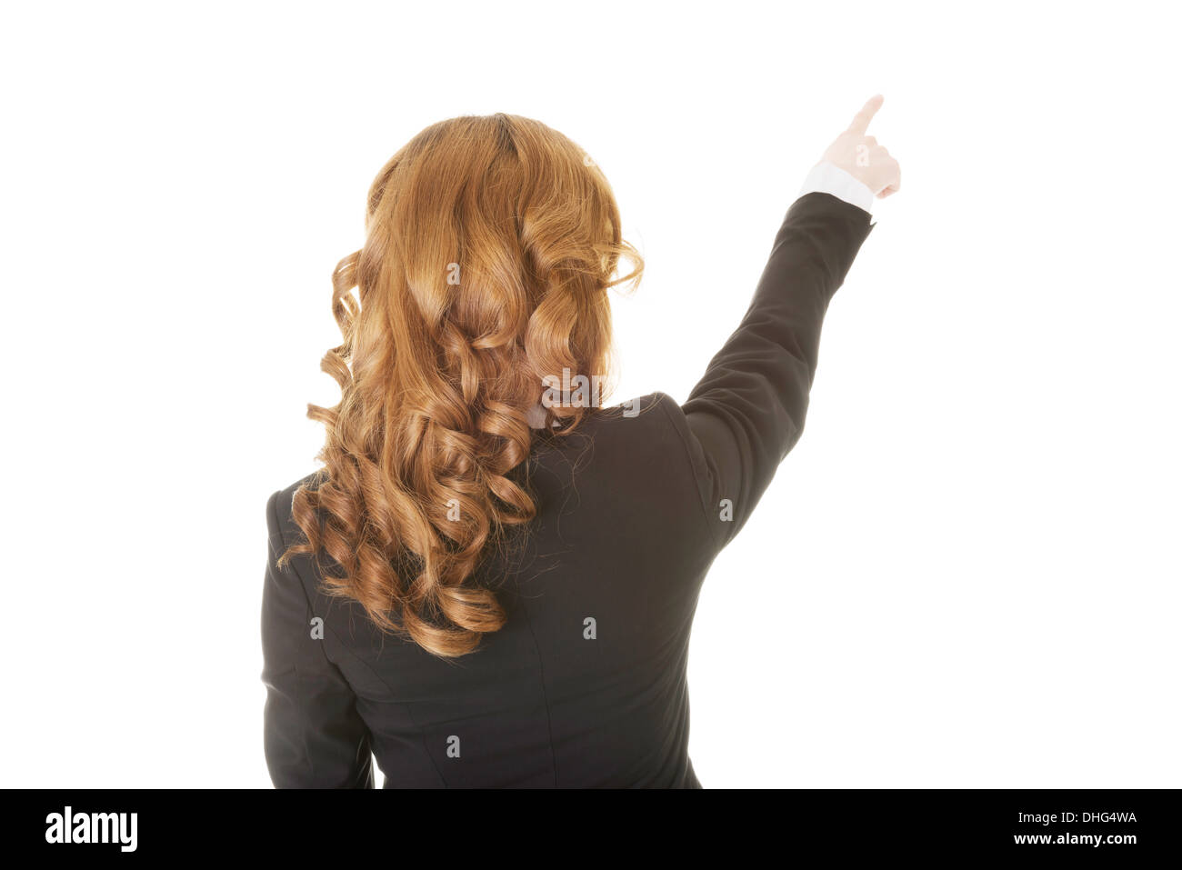 Beautiful woman standing and pointing up, back view. Isolated on white ...