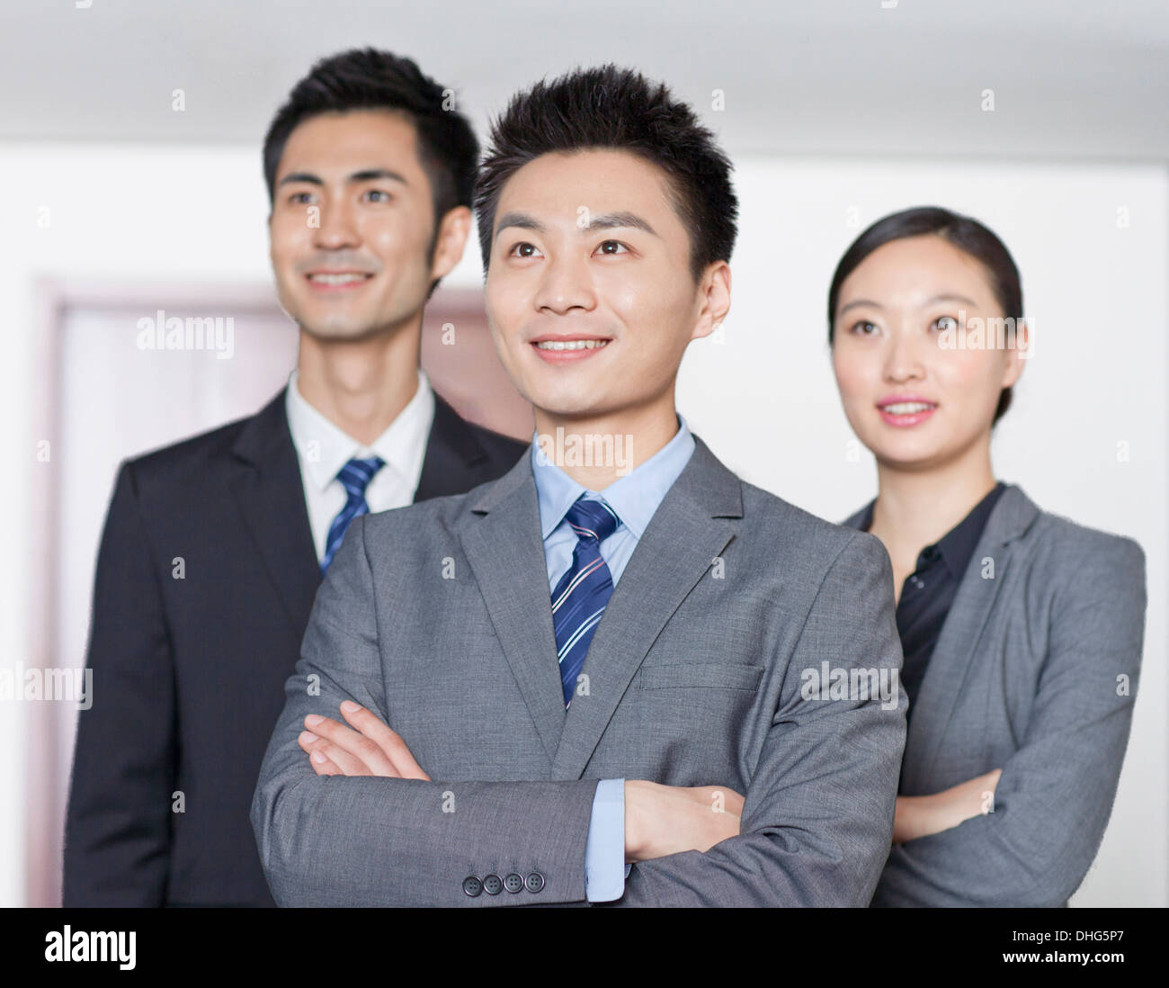 young office workers with hands crossed indoors,portrait Stock Photo ...