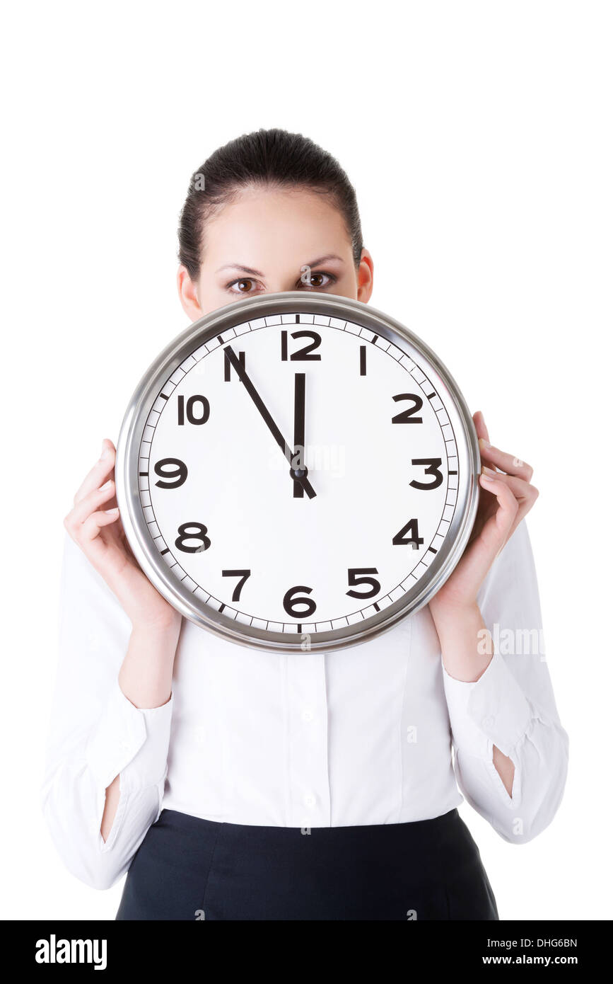 Business woman holding a clock in front of her face. Isolated on white ...