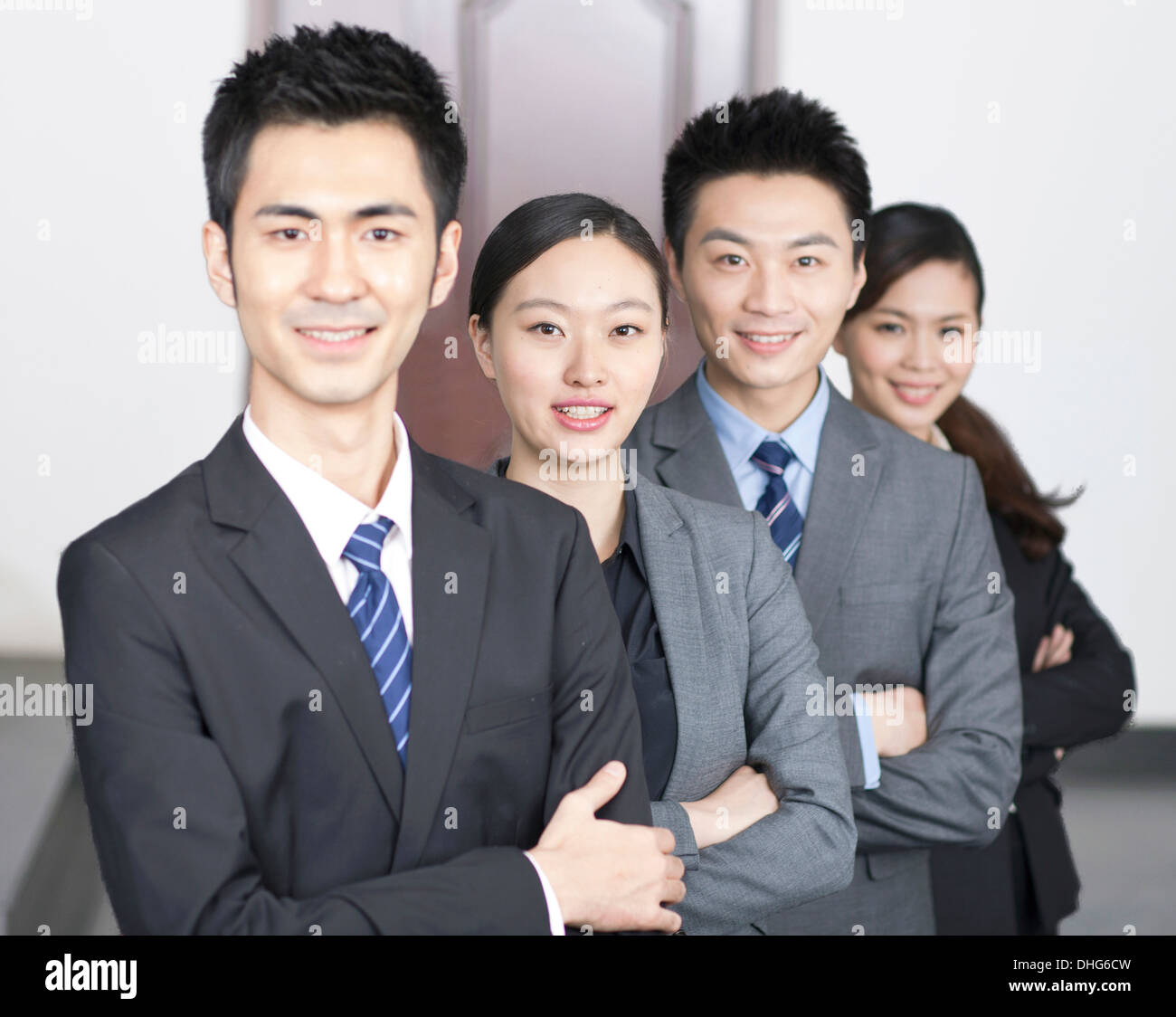 young office workers with hands crossed indoors,portrait Stock Photo ...